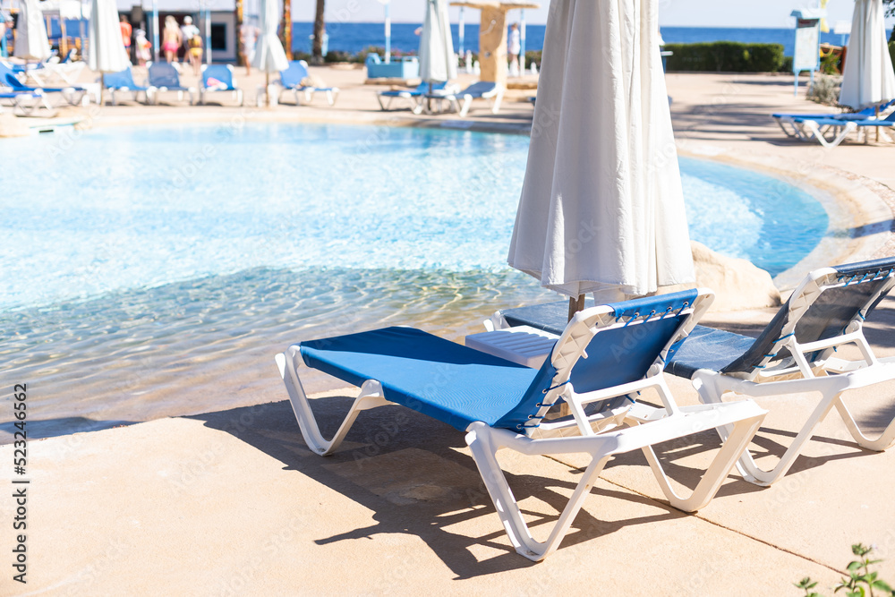 Swimming pool with clean clear water, nobody. Square shaped pool with ...