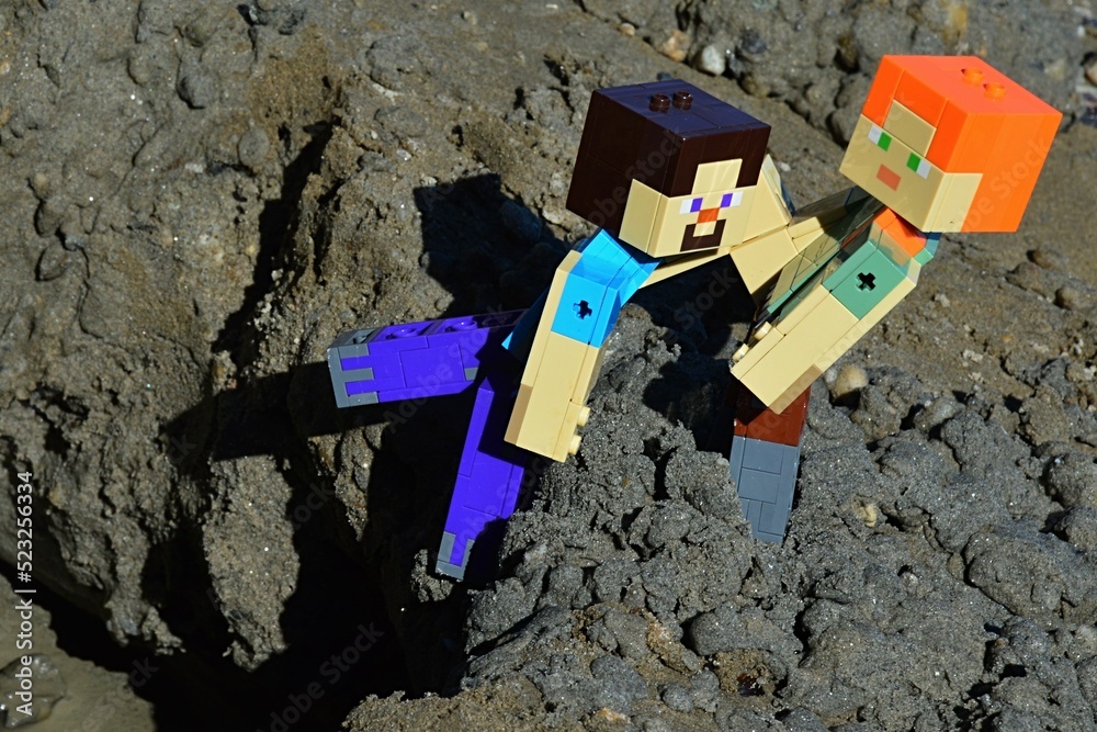 LEGO Minecraft figure of Alex pulling her friend Steve from large black ...