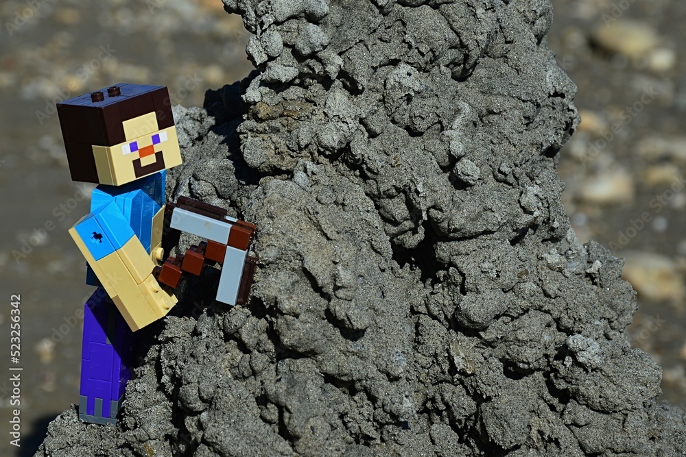 LEGO Minecraft large figure of Steve climbing on a black sand hill with ...