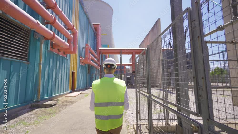Engineer walking at nuclear power plant. The engineer controlling the ...