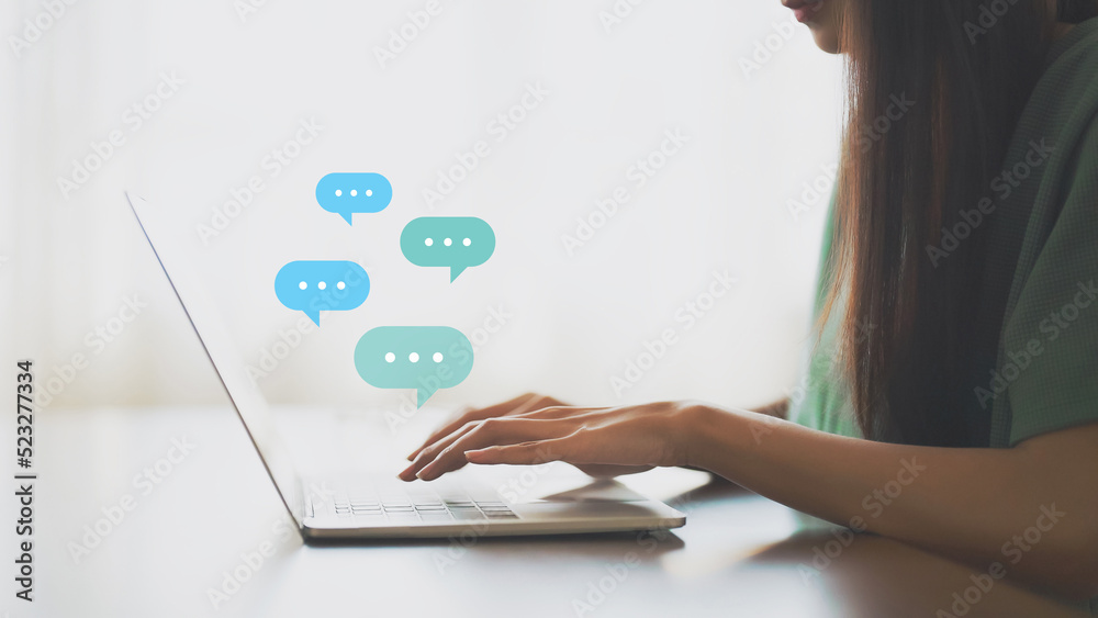 Woman using computer laptop on wood desk. Online message live chat ...