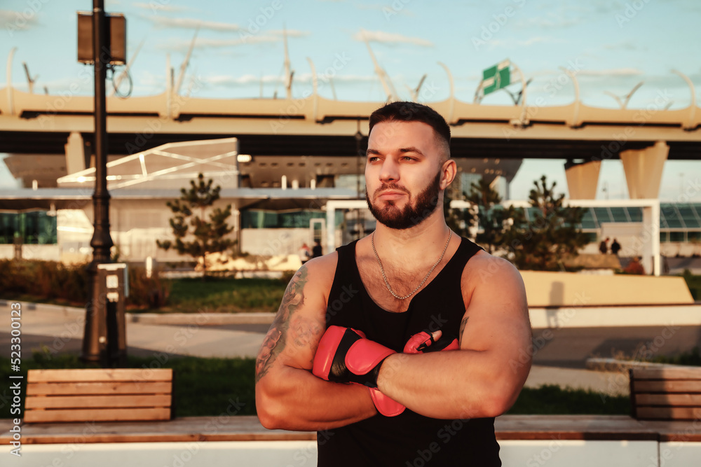 Portrait athletes man boxer fighter with boxing gloves posing with arms ...