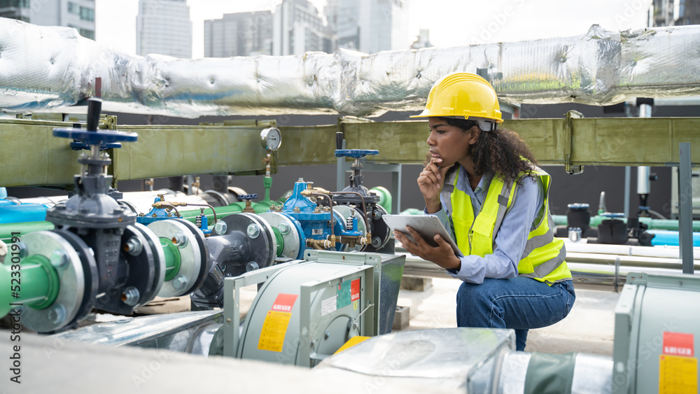 Service engineer woman dark skin wearing uniform and safety helmet ...