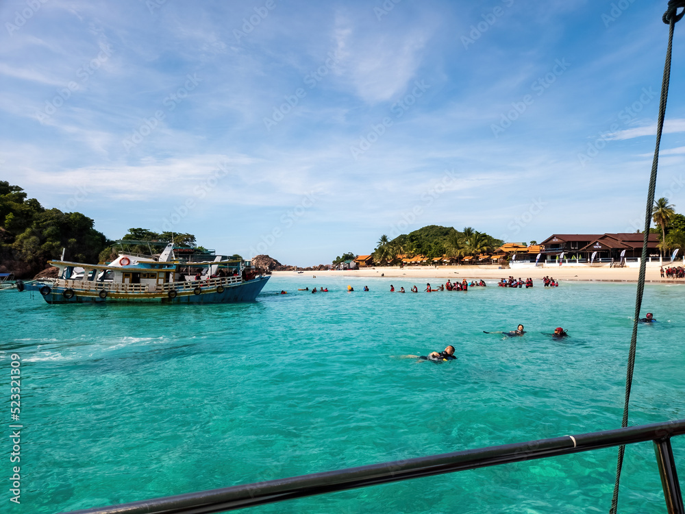 Redang, Malaysia - May 10, 2022 Boats, turquoise water and white sand ...