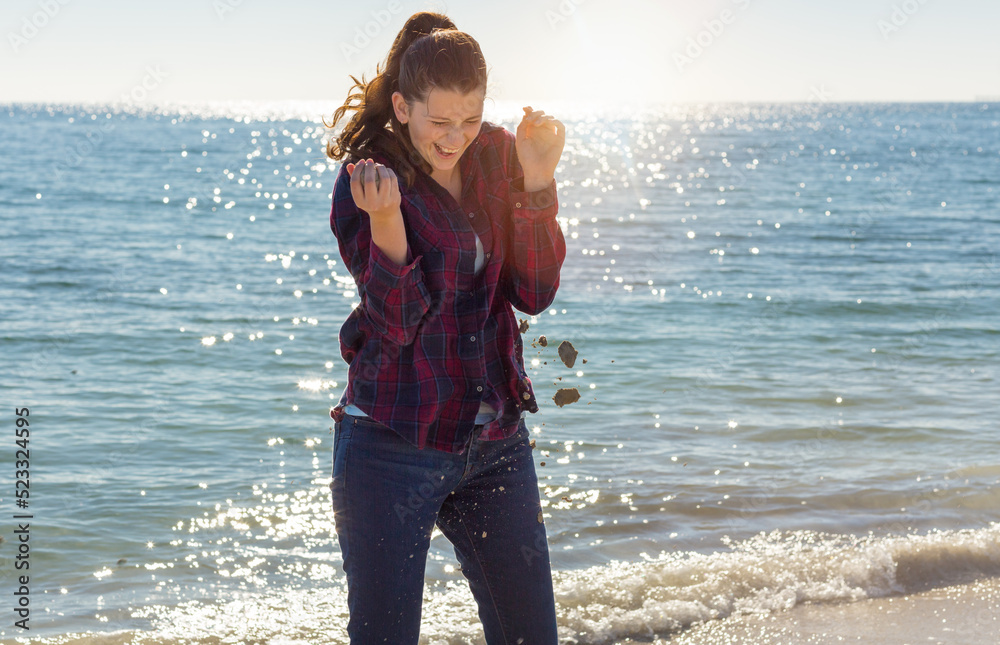 Teenage girl on the beach in sand fight Stock Photo | Adobe Stock
