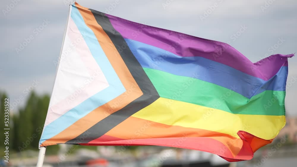 LGBTQ rainbow flag in a residential harbour area european city closeup ...
