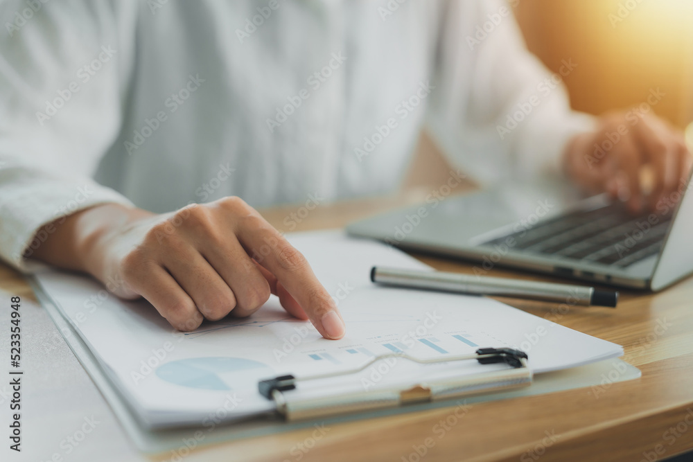 Professional businesswoman working on documents report show chart and ...