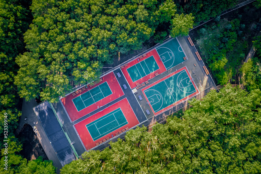 Drone top down view of beautiful sport fields in green summer city park ...