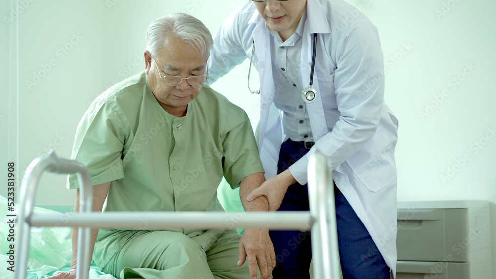 Professional doctor or physical therapist teaching senior elderly male ...