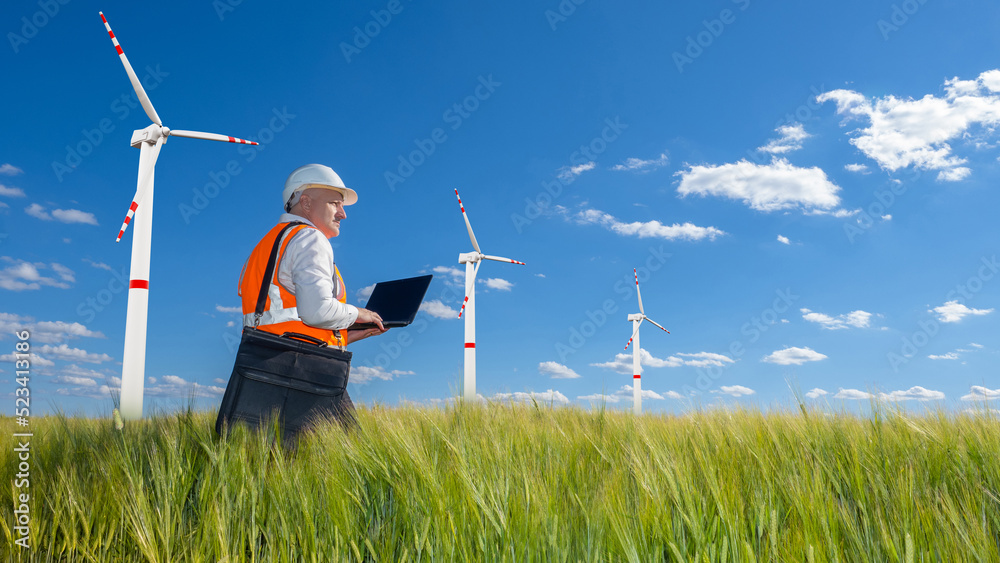 Man next to wind generators. Human with laptop in front power plant ...