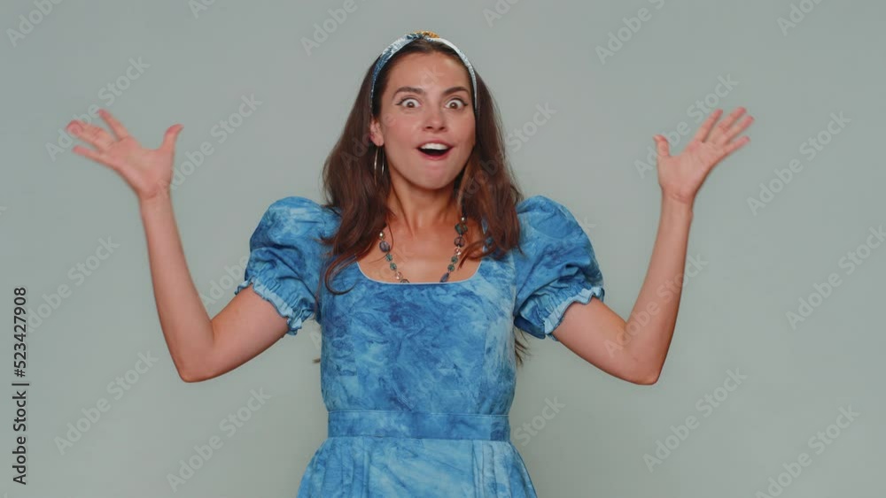 Excited amazed young woman touching her head and showing explosion ...
