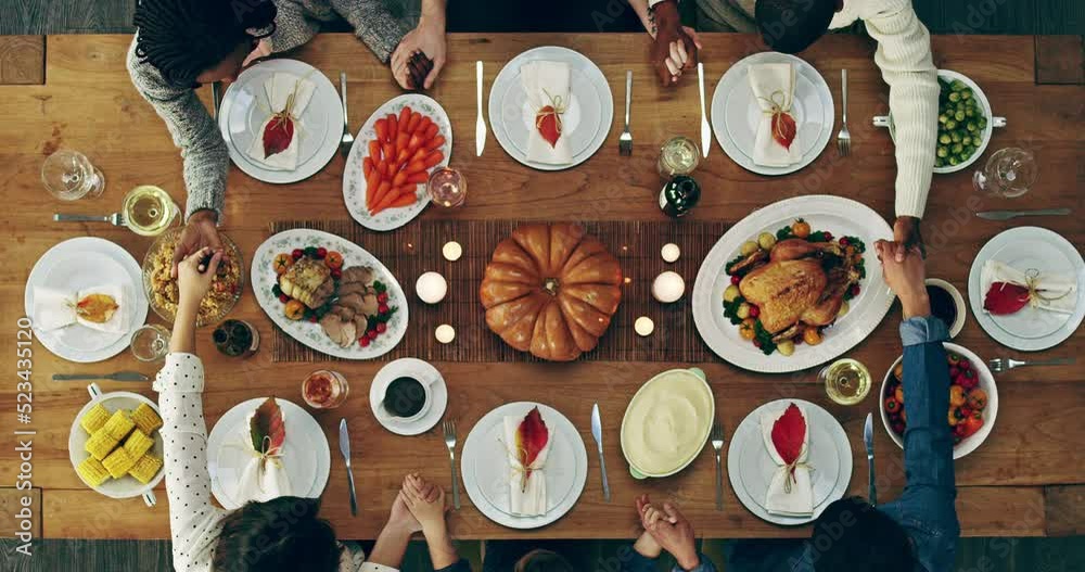 Happy group of diverse religious friends having dinner and holding ...