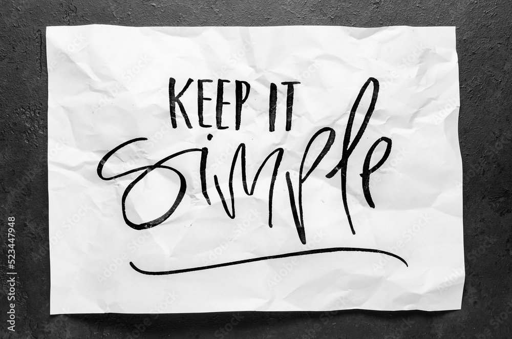 Keep it simple. Lettering on crumpled white paper. Handwritten text ...