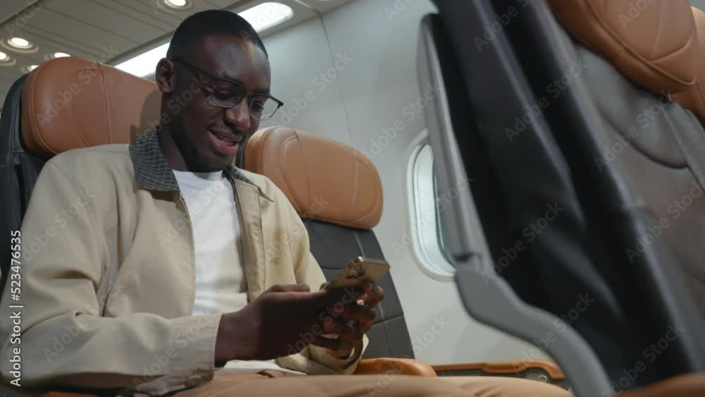 Passenger businessman using mobile phone test wifi connection in plane ...