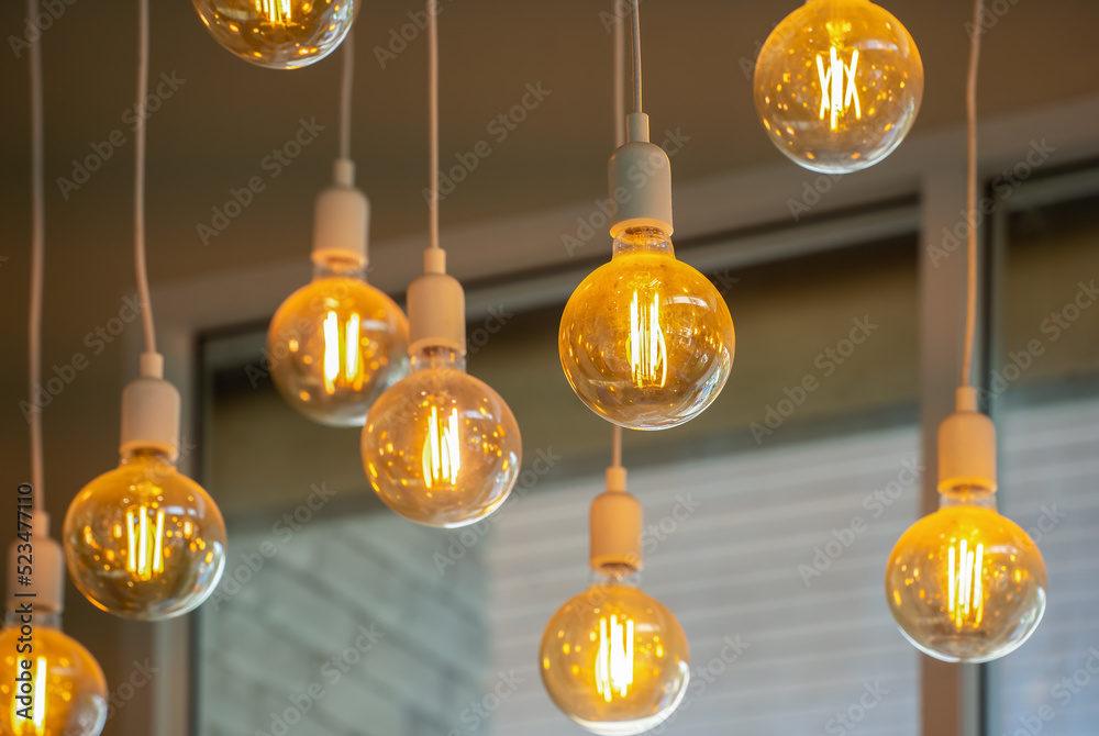 Vintage tungsten filament multiple lamps hanging from the ceiling on a ...