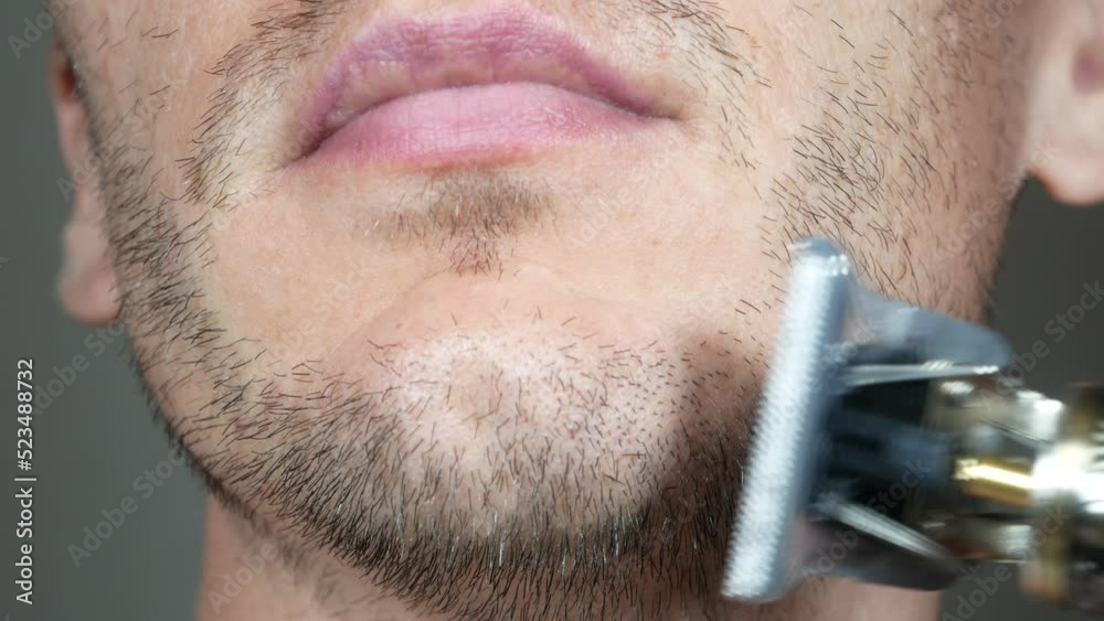 Video Stock Man is cutting beard by Electric metal razor or dry shaver ...