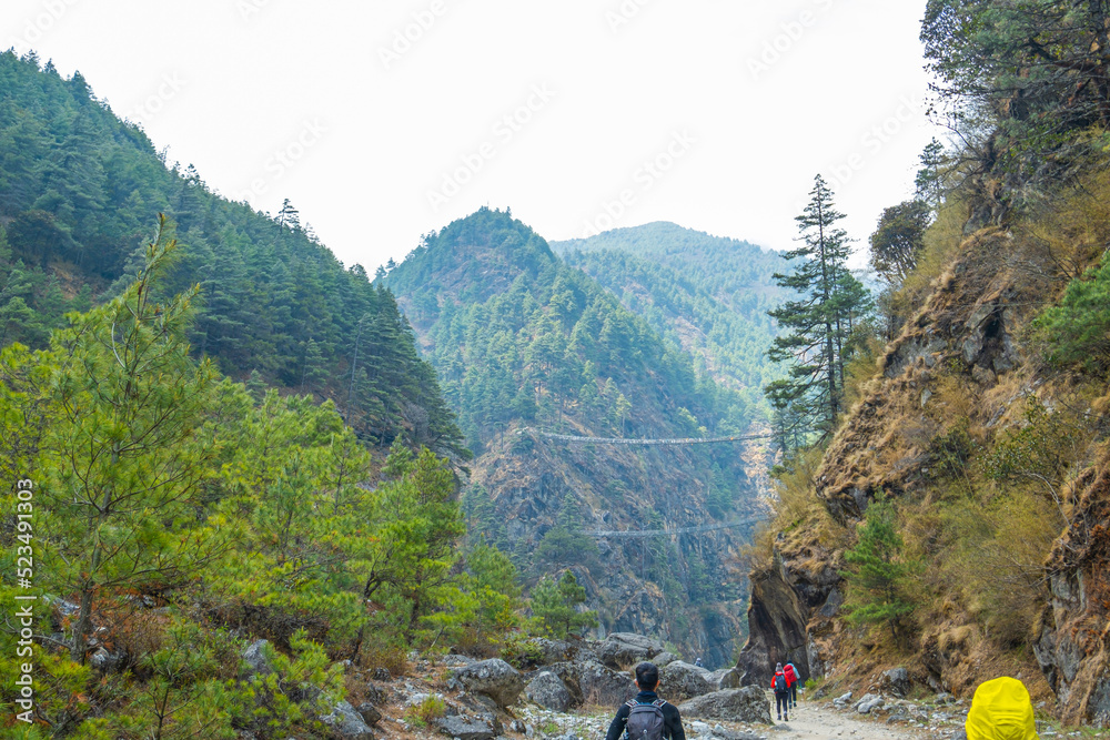 Hikers on the way to Tenzing-Hillary Suspension Bridge, the bridge ...