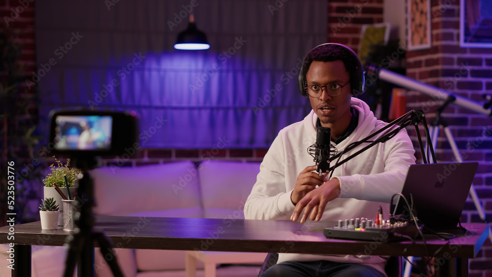 African american content creator recording vlog using digital video ...