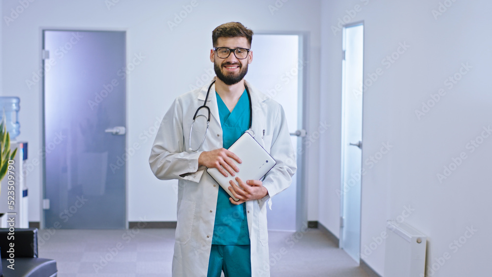 Good looking doctor man standing in front of the camera in the modern ...