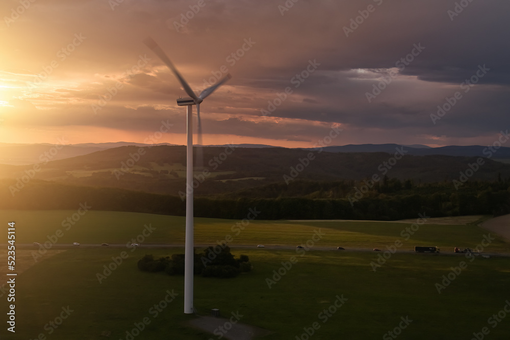 Aerial view of Wind power plant in full load, illuminated with dramatic ...