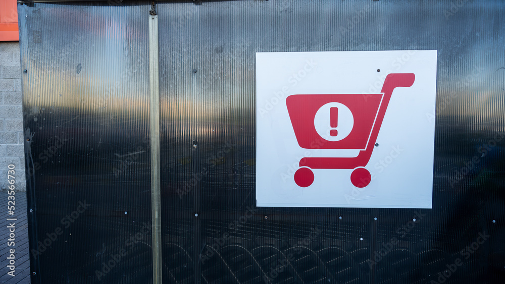 Sign of shopping trolleys parking lot. Shopping carts return point on a ...