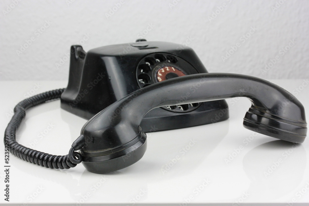 old antique dial operated telephone black out of bakelite on white ...