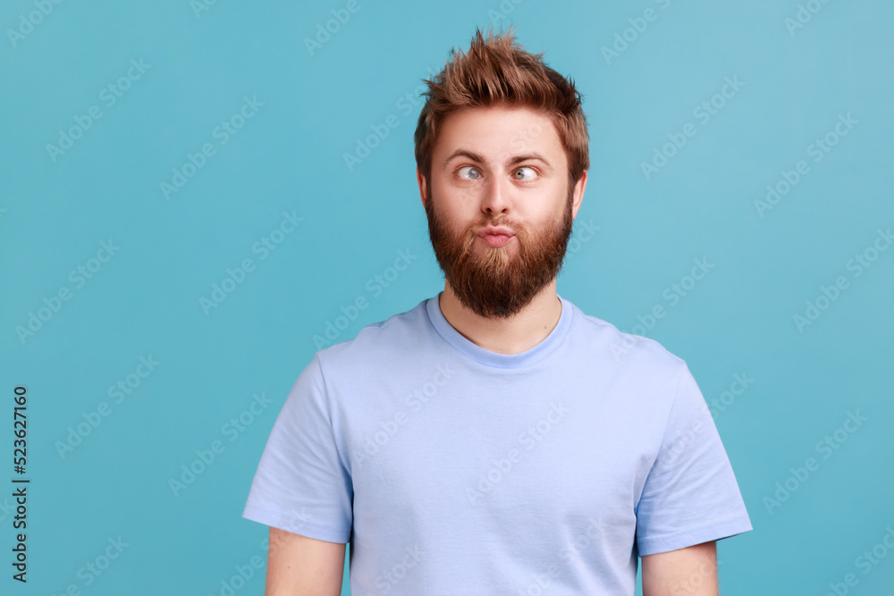Portrait of man making silly humorous face with eyes crossed, showing ...