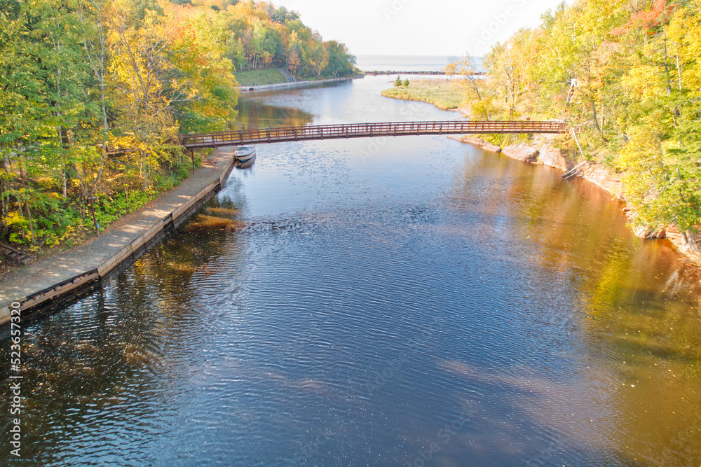Aerial perspective of a wood bridge over a river leading into Lake ...