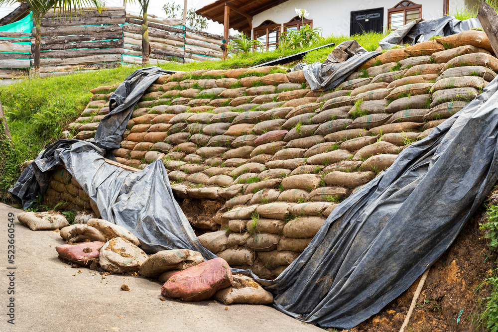 Poster Retaining wall with sacks filled with earth to prevent ...