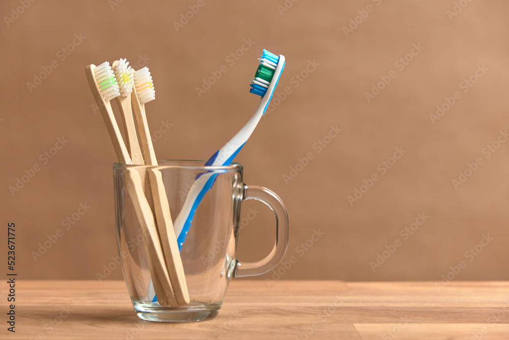 Toothbrushes, a plastic one and a set of three ecological made of ...