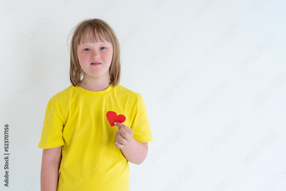 Sweet little girl with Down Syndrome, playing with paper heart. world ...