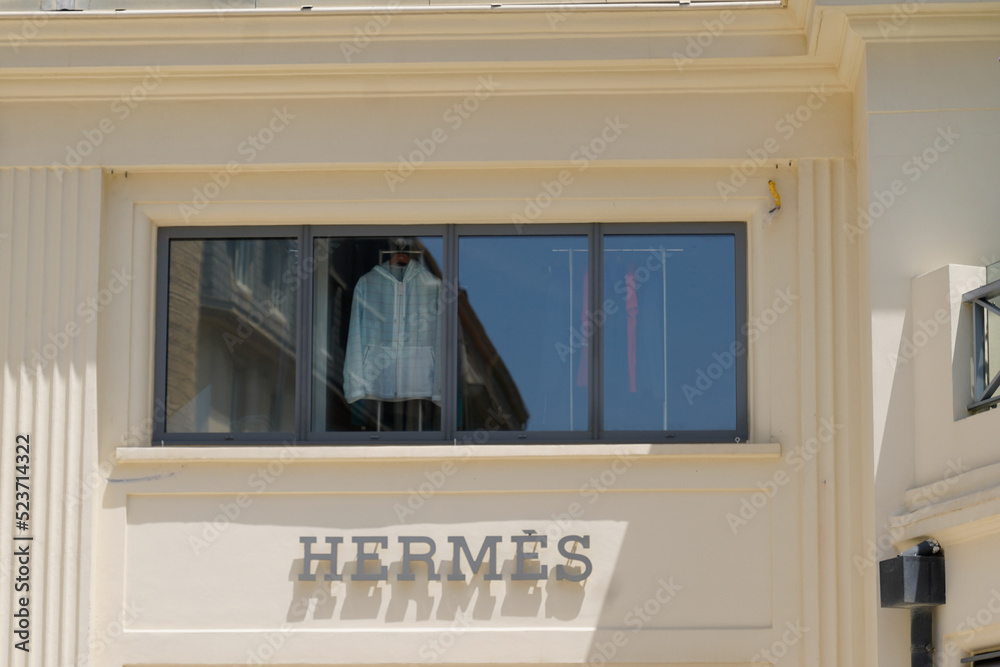 hermes logo facade and sign text front of store fashion brand clothes ...