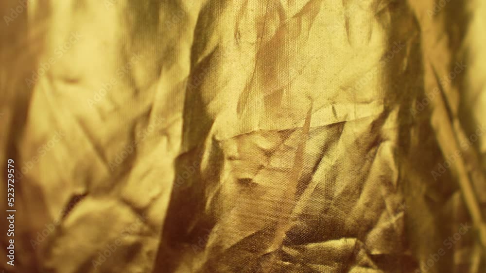 Wrinkled golden color cloth background with changing light Stock 비디오 ...