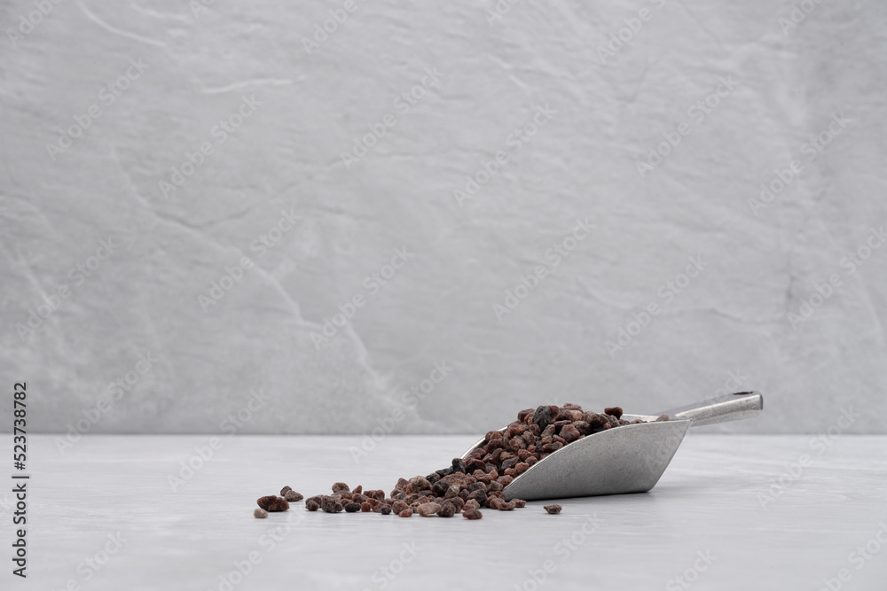Himalayan black salt in spoon on stone white texture background Stock ...