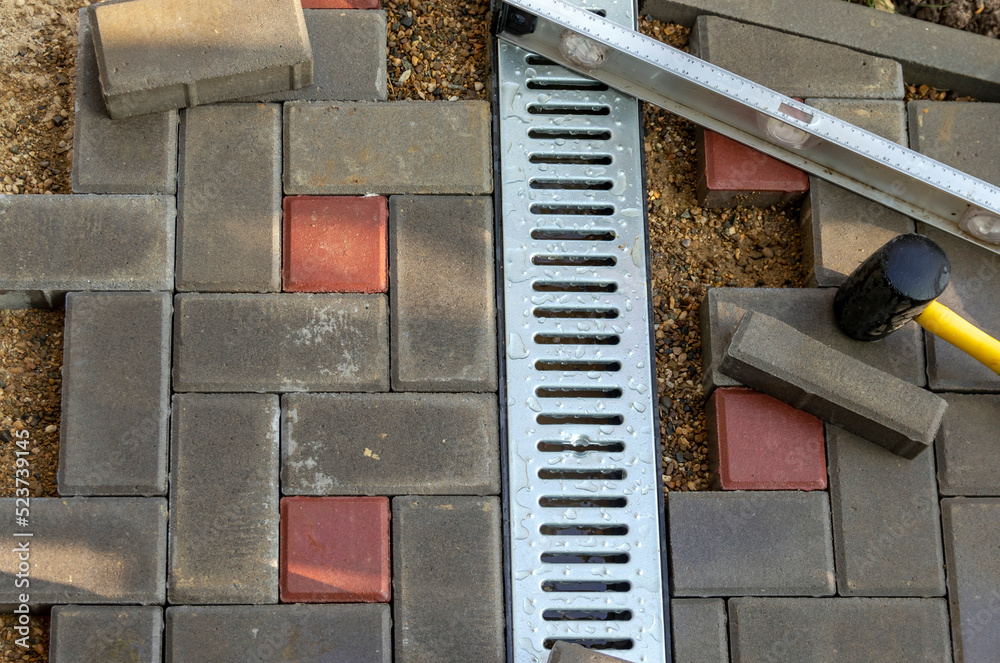 Iron drainage mesh. Drainage for water after rain on the sidewalk ...