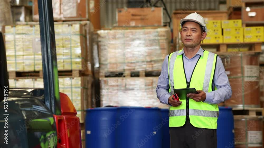 warehouse manager. Warehouse manager and staff driving forklift ...