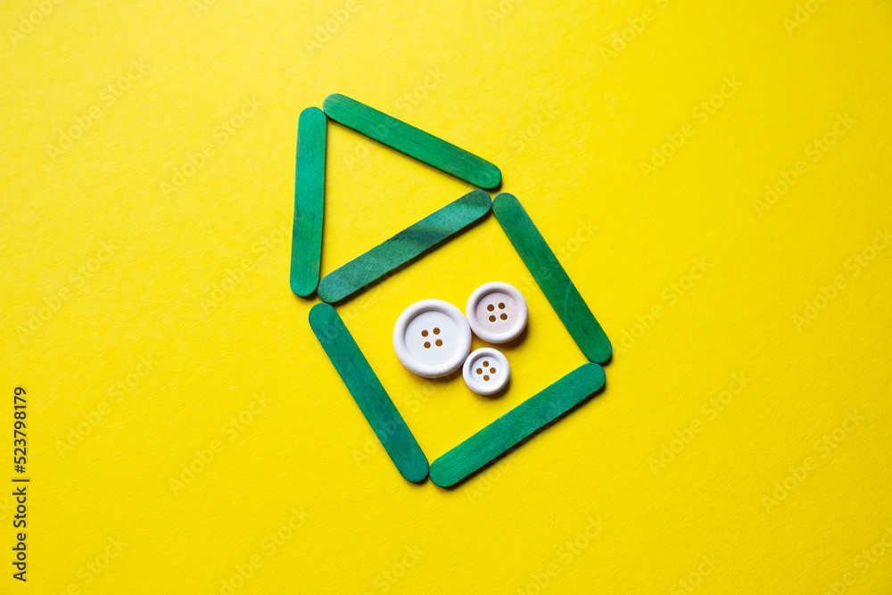 house from wooden green sticks on a yellow background side view ...