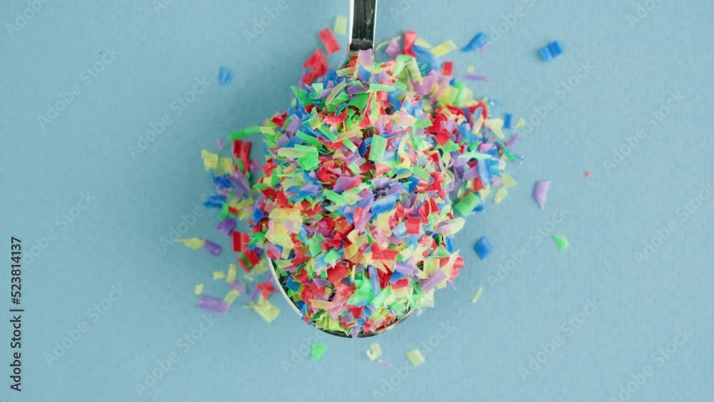 Microplastic pollution, plastic particles in spoon close-up, garbage ...