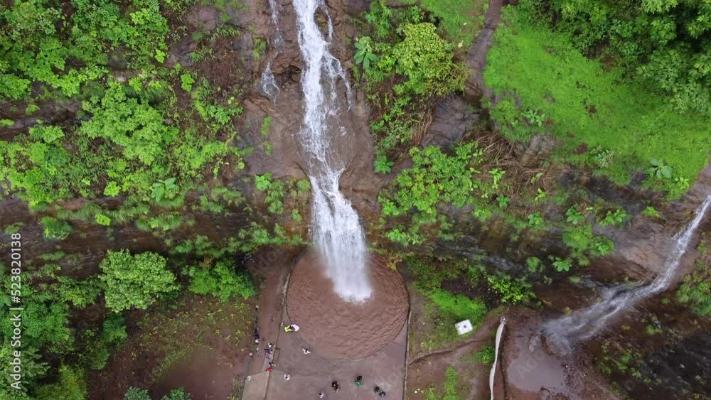 Lush green landscape with waterfalls in full flow during the monsoon ...