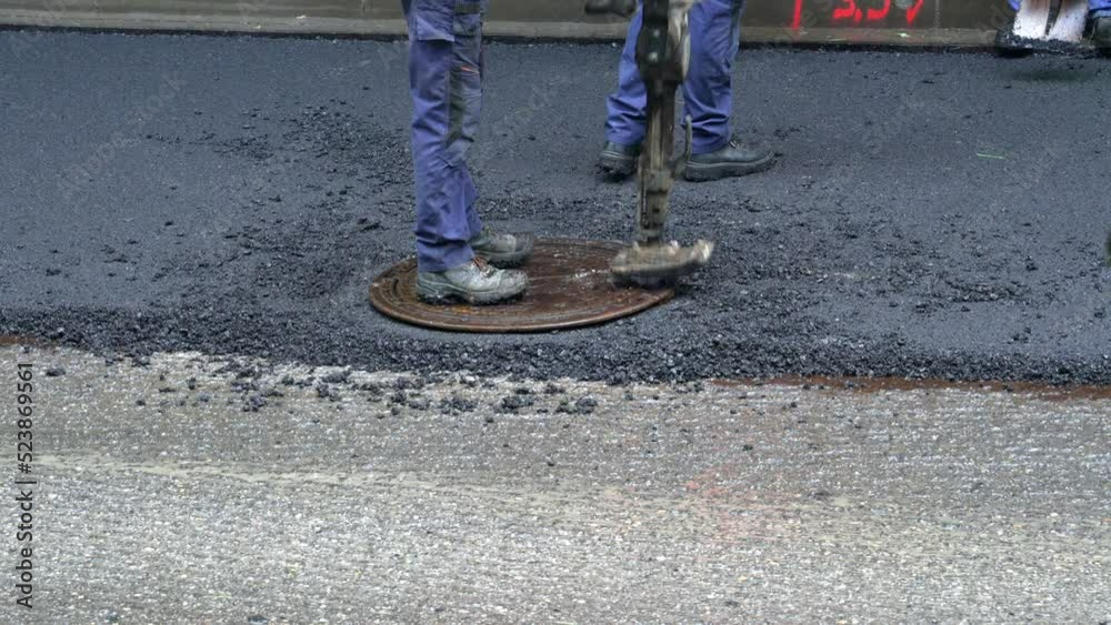 Replacing old asphalt when repairing the road surface. A road worker in ...