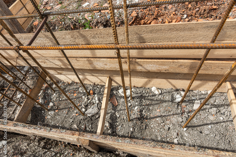 Reinforcement covered with earth during the collapse of the formwork ...