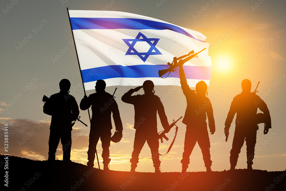 Silhouettes of soldiers with Israel flag against the sunrise in the ...