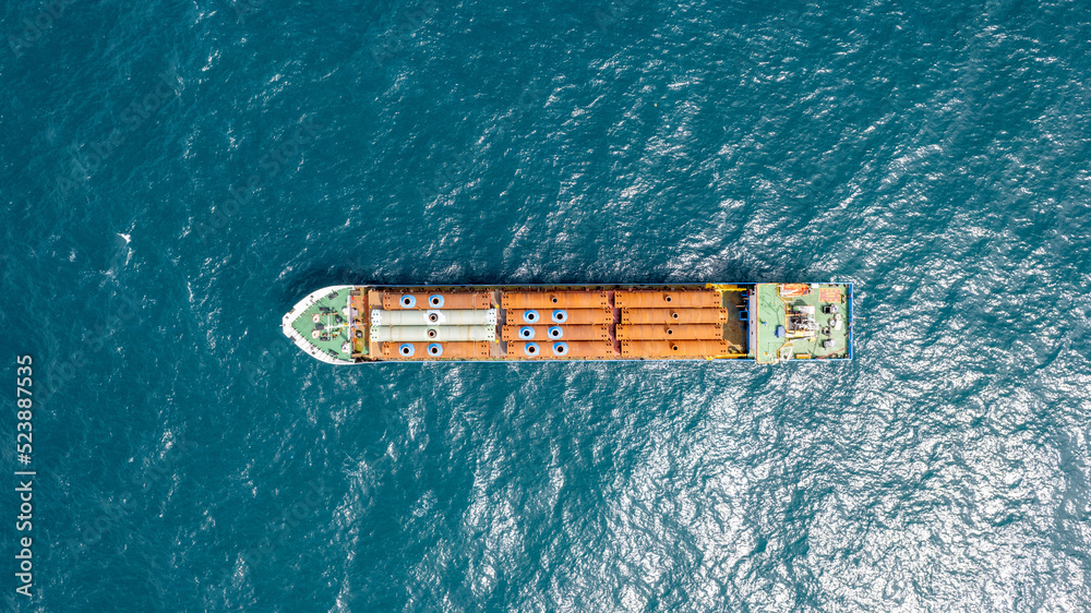 Cargo ship carries industrial metal pipes at sea. Stock Photo | Adobe Stock