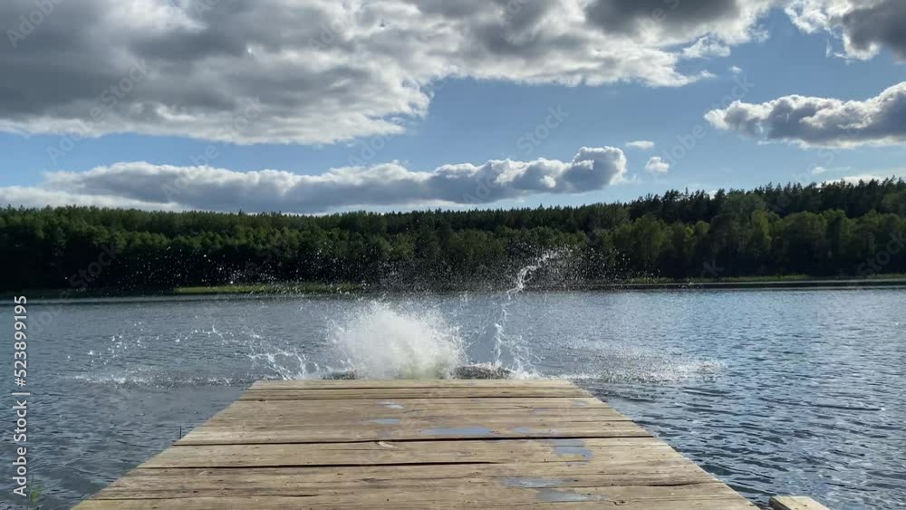 Handsome young man jumping into the water and making a splash. Person ...