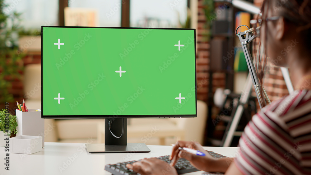 Businesswoman working remotely with greenscreen on computer, using ...