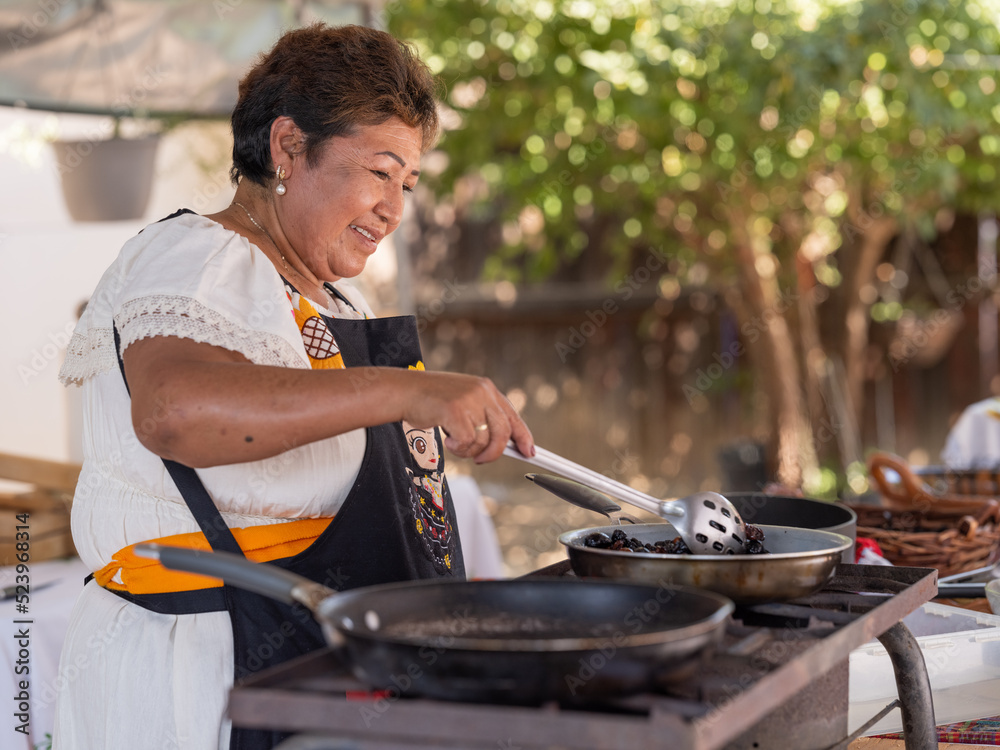 Indigenous woman smiling while cooking in an outdoor kitchen Stock ...