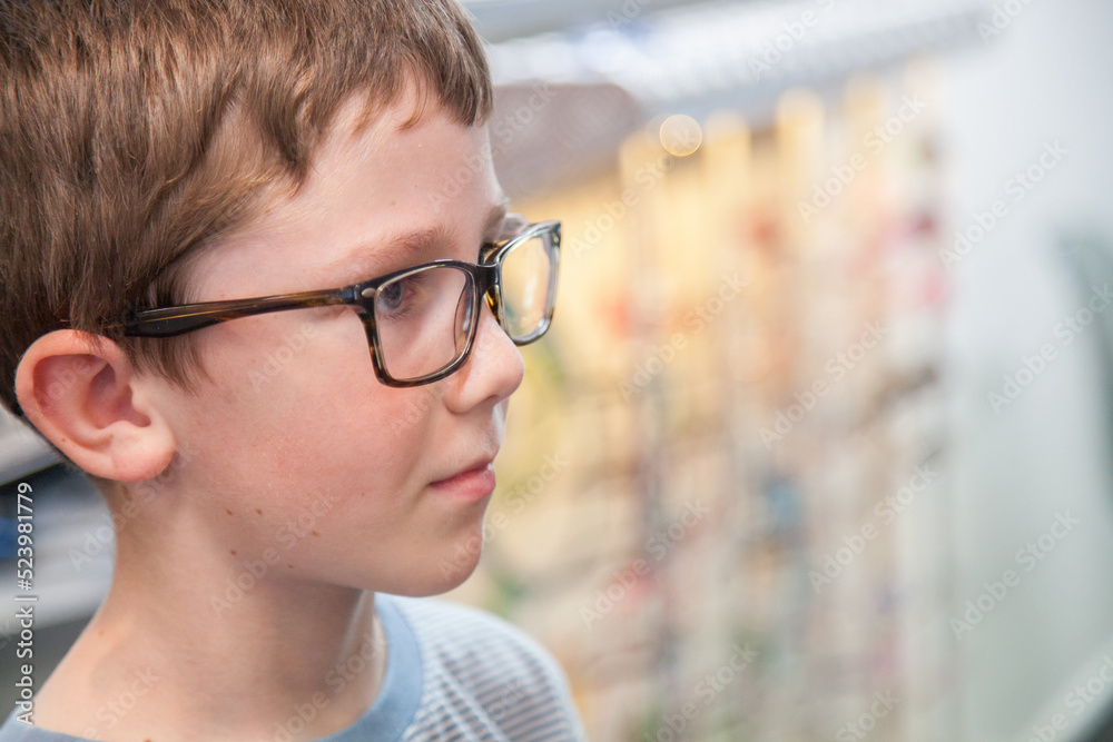 Young boy trying on different frames for new glasses Stock Photo ...