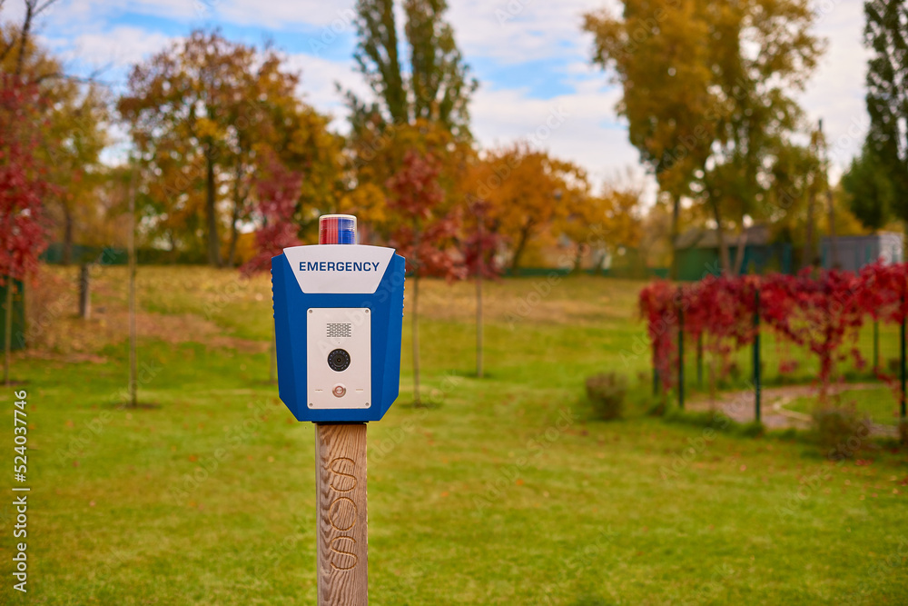 Panic alarm for call to police, emergency button in public park. Blue ...