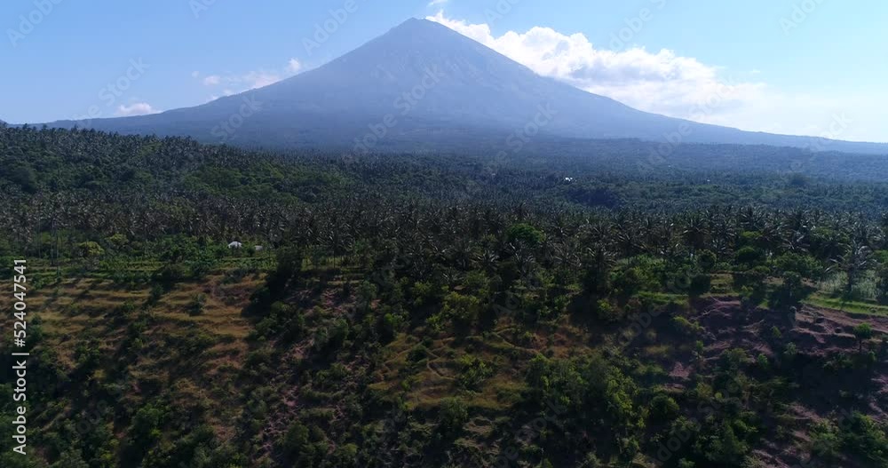 Volcano with its side covered in tropical vegetation, hill at the ...