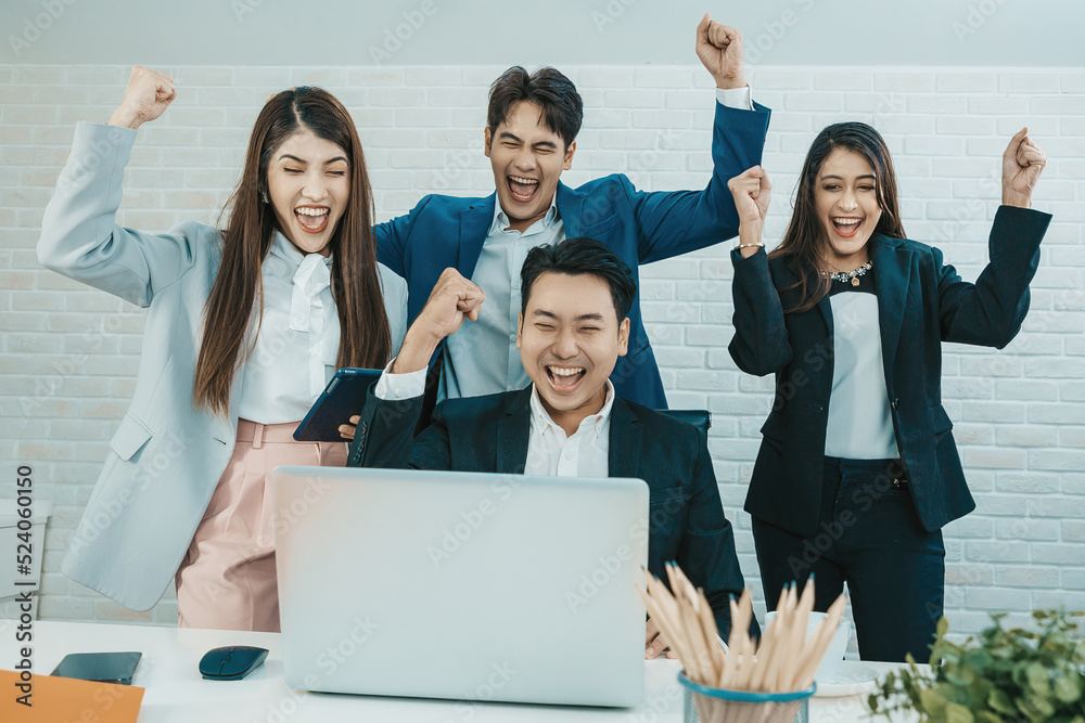 Happy diverse employees team celebrating teamwork success, business achievement at meeting.Group ...